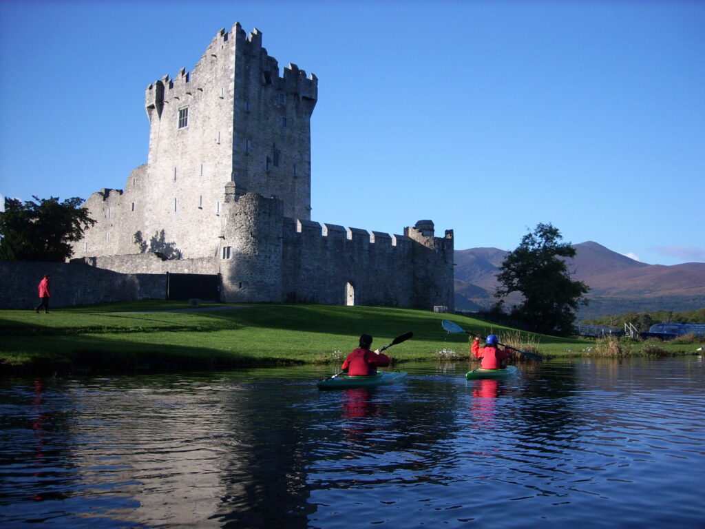 Kayaking Past Ross Castle In Killarney National Park - Outdoors Ireland
